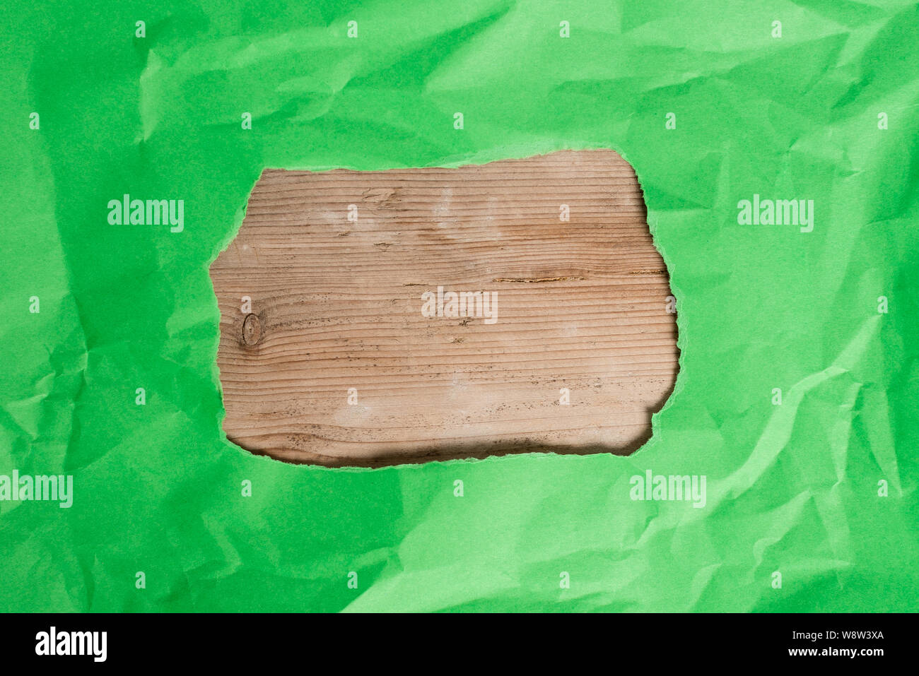 Green crumpled ripped colored paper sheet centre torn colorful ...