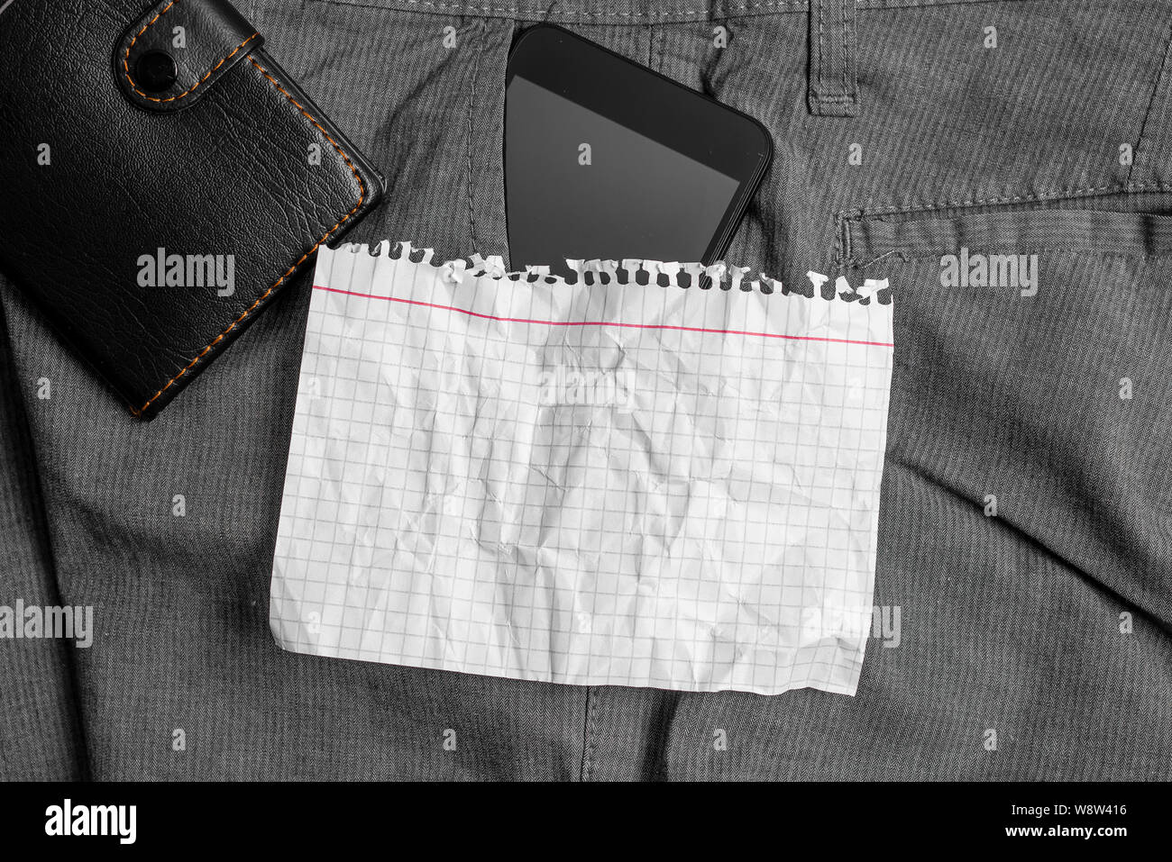Smartphone device inside trousers front pocket with wallet and note ...