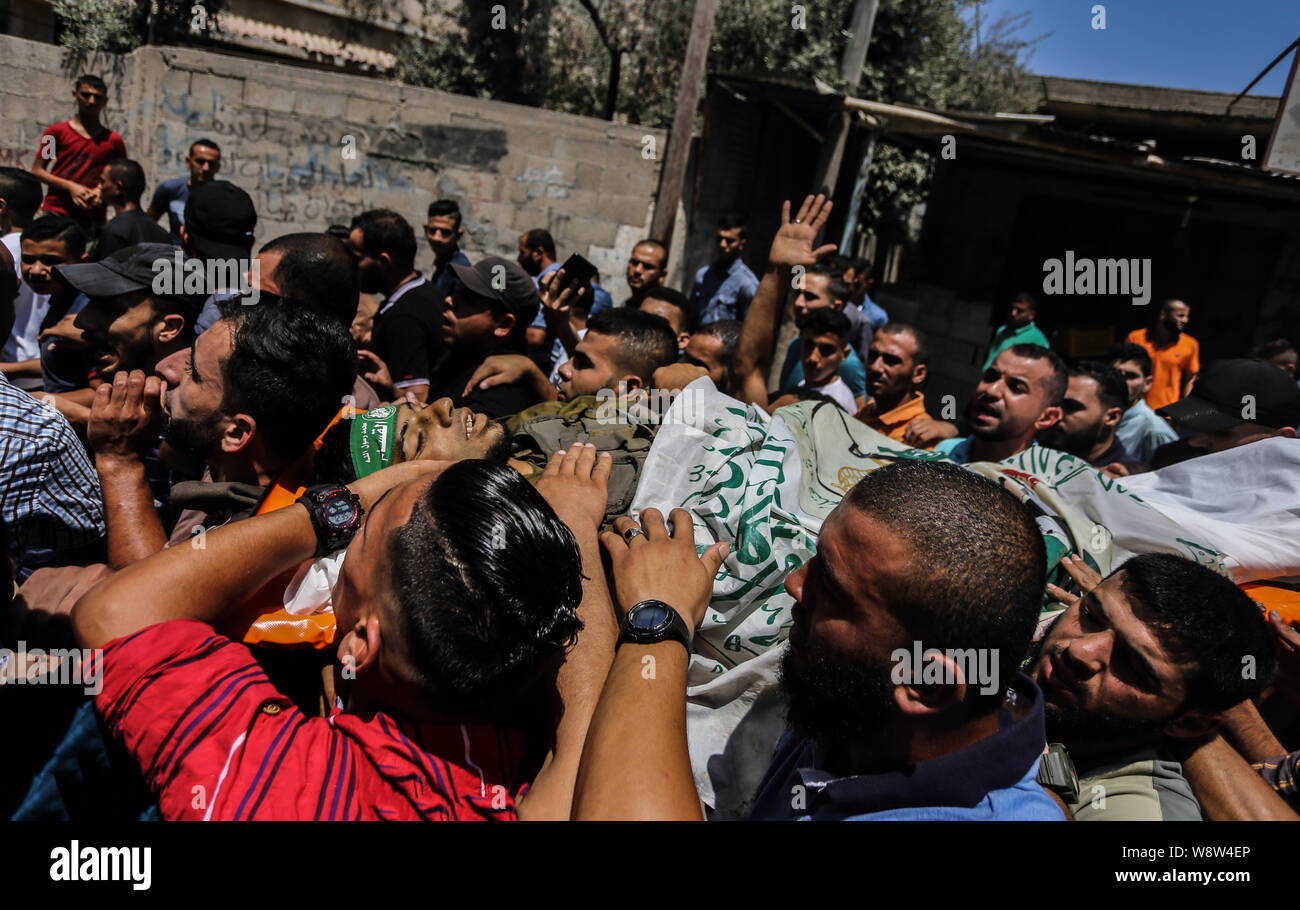 (EDITOR’S NOTE: Image depicts death.)Mourners carry the body of ...