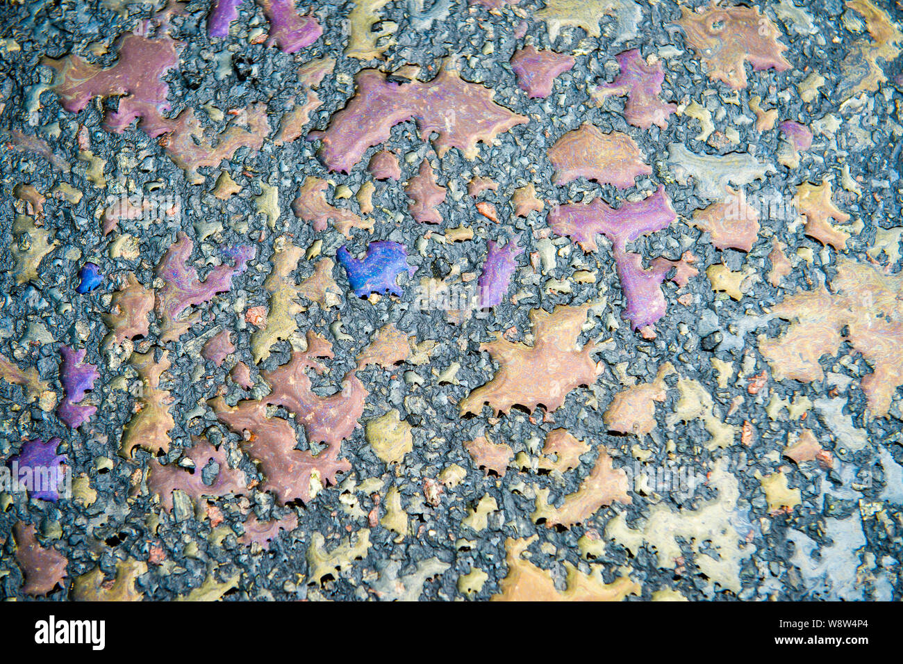Beautiful pollution background of oil slick water reflecting rainbow ...