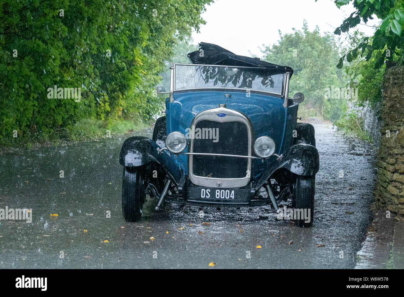 1929 Ford Roadster driver caught in heavy rain, Frome Somerset UK Stock ...