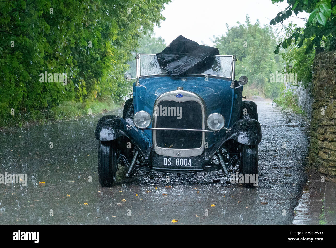 1929 Ford Roadster driver caught in heavy rain, Frome Somerset UK Stock ...