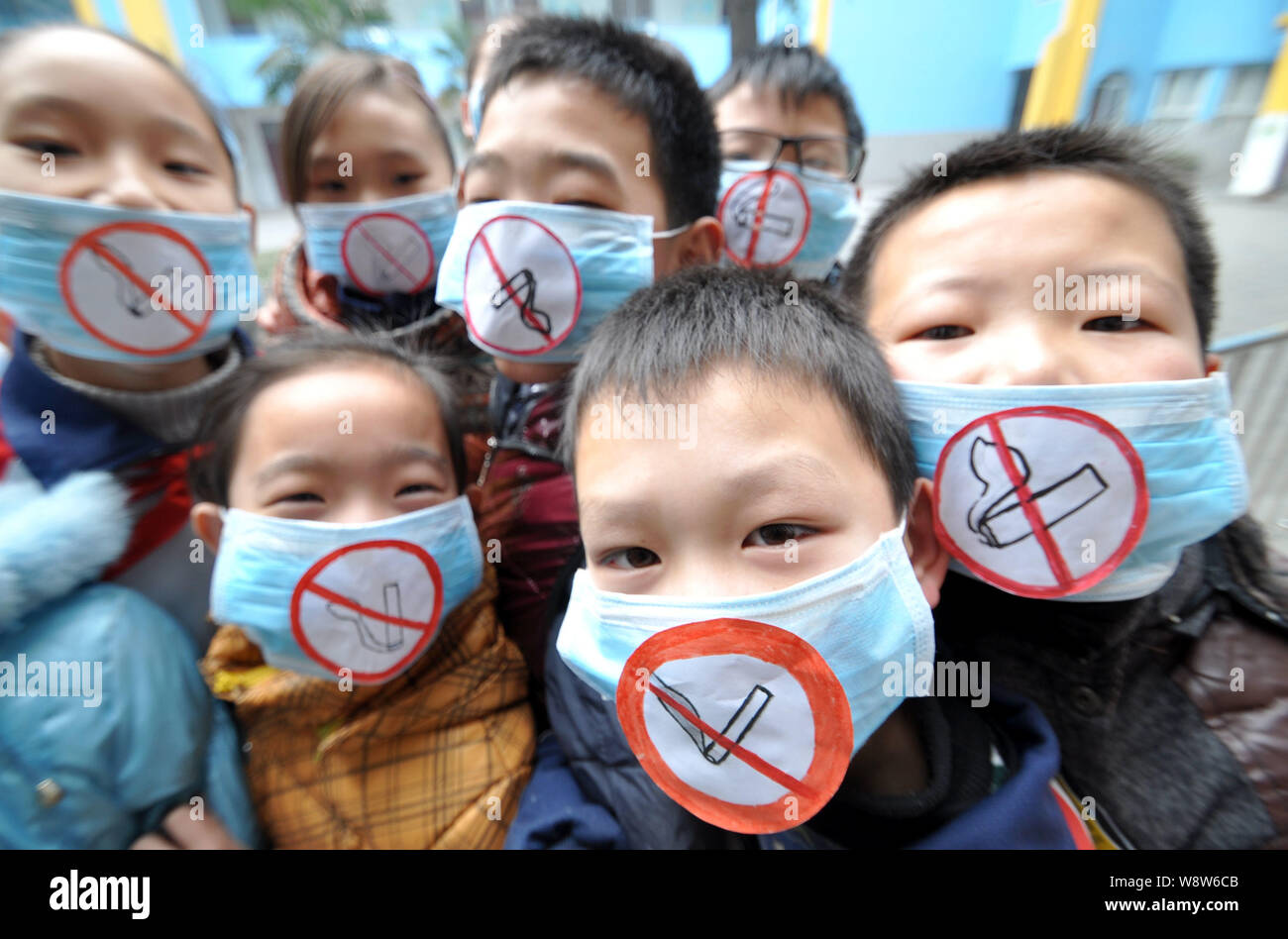 --FILE--Young Chinese students show their face masks with No-Smoking ...