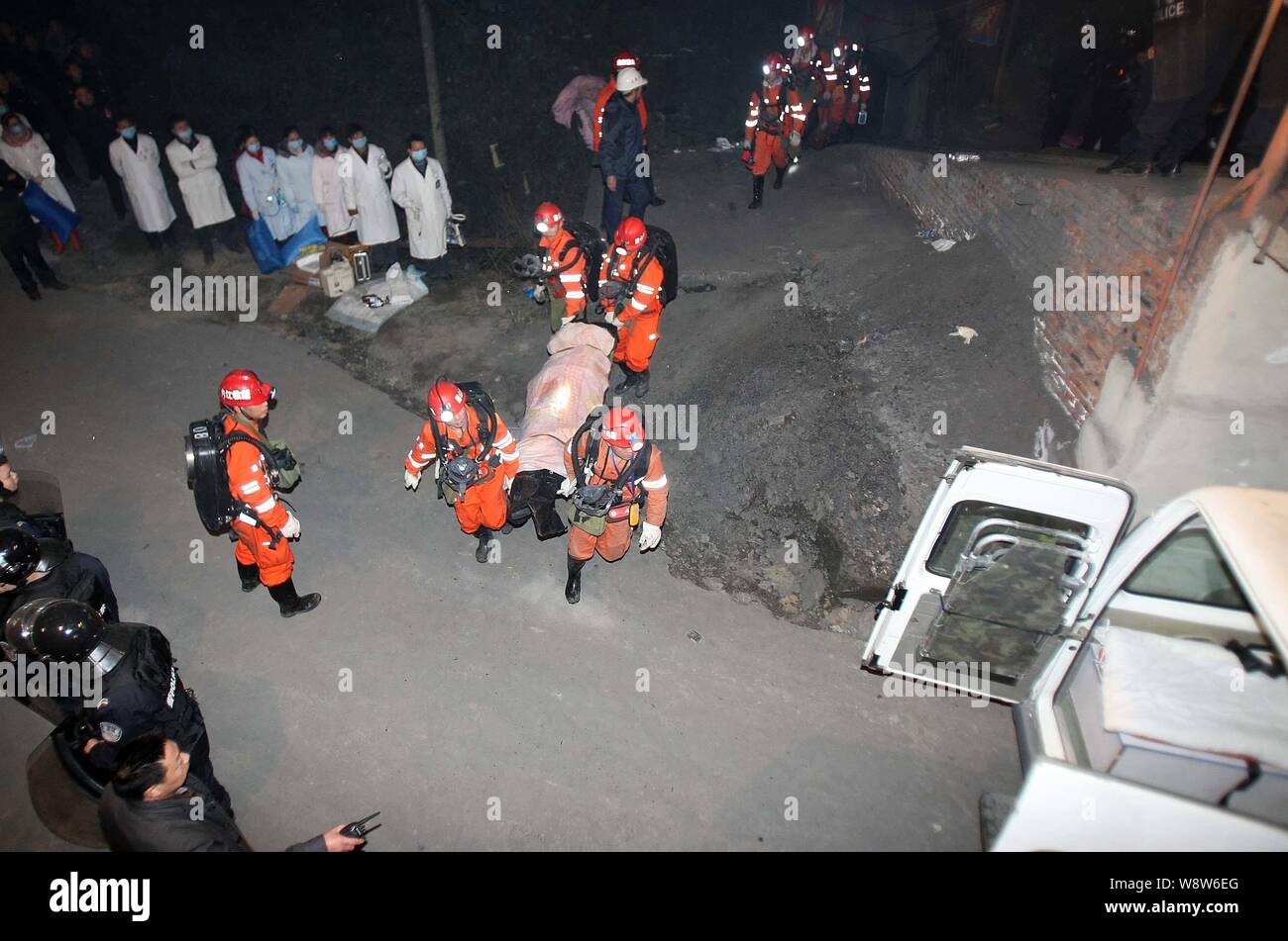 Rescuers carry a miner to an ambulance after the gas explosion at a ...