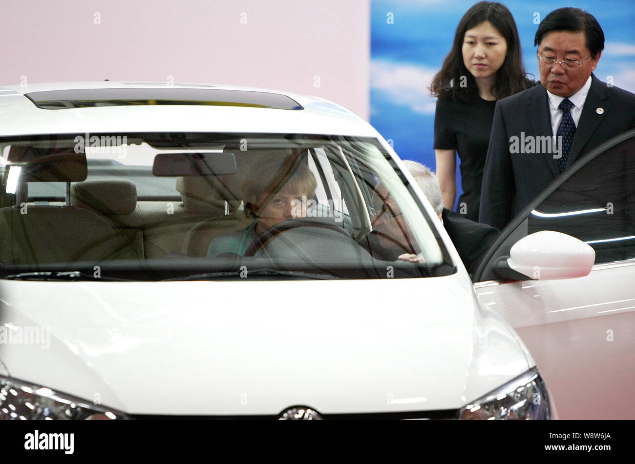 German Chancellor Angela Merkel, left, tries out an All New Jetta next ...