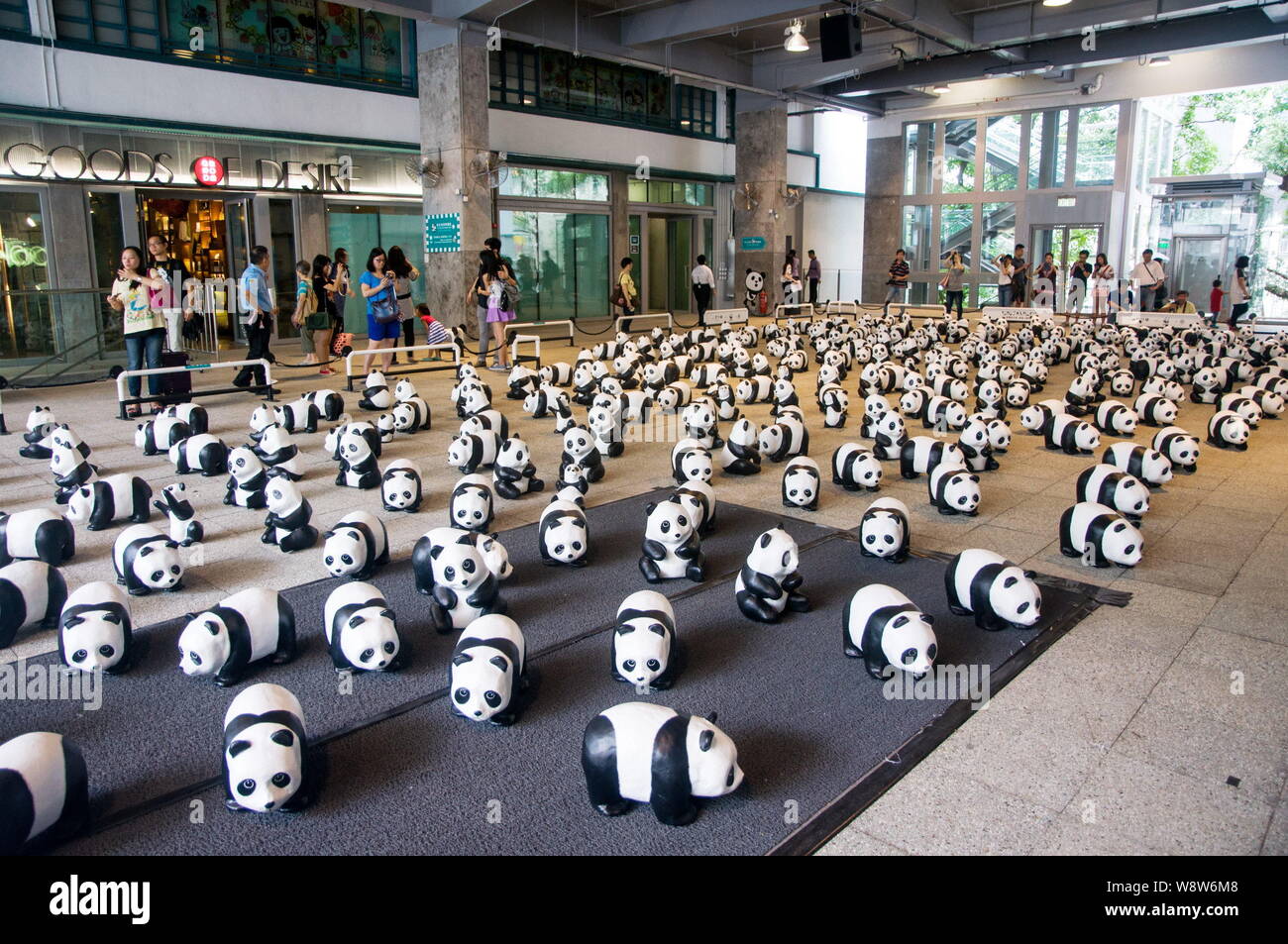 Visitors take photos of the paper pandas created by French artist Paulo ...