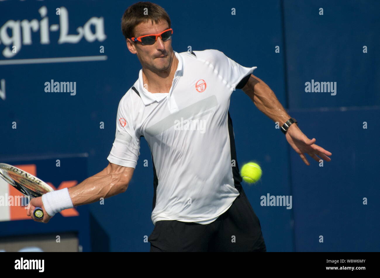 Tommy Robredo of Spain returns a shot to Santiago Giraldo of Colombia ...