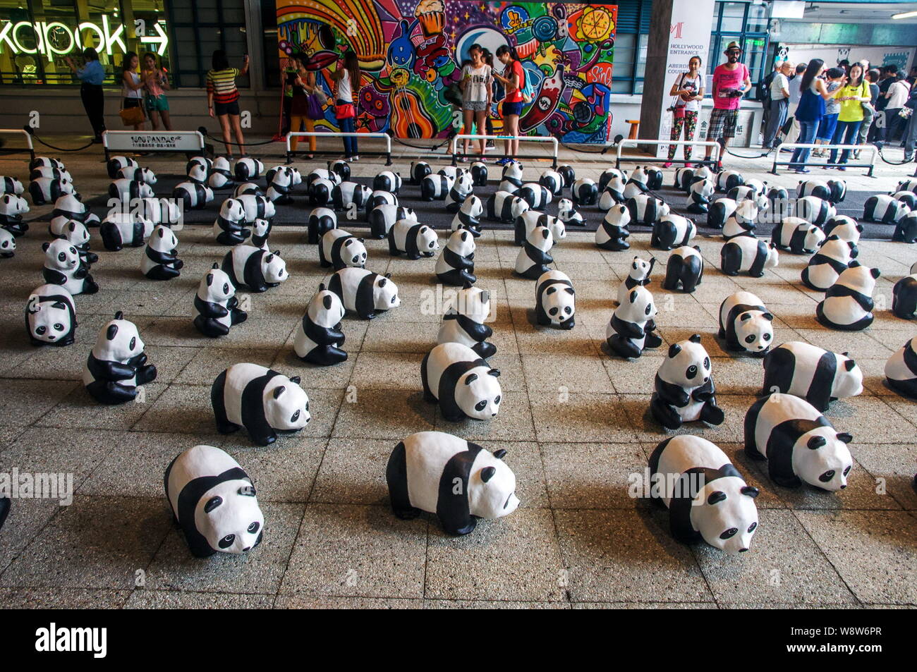 Visitors look at the paper pandas created by French artist Paulo ...