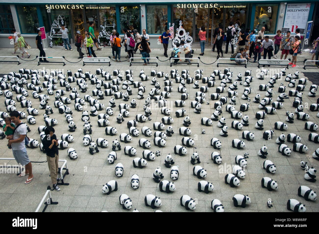 Visitors take photos of the paper pandas created by French artist Paulo ...
