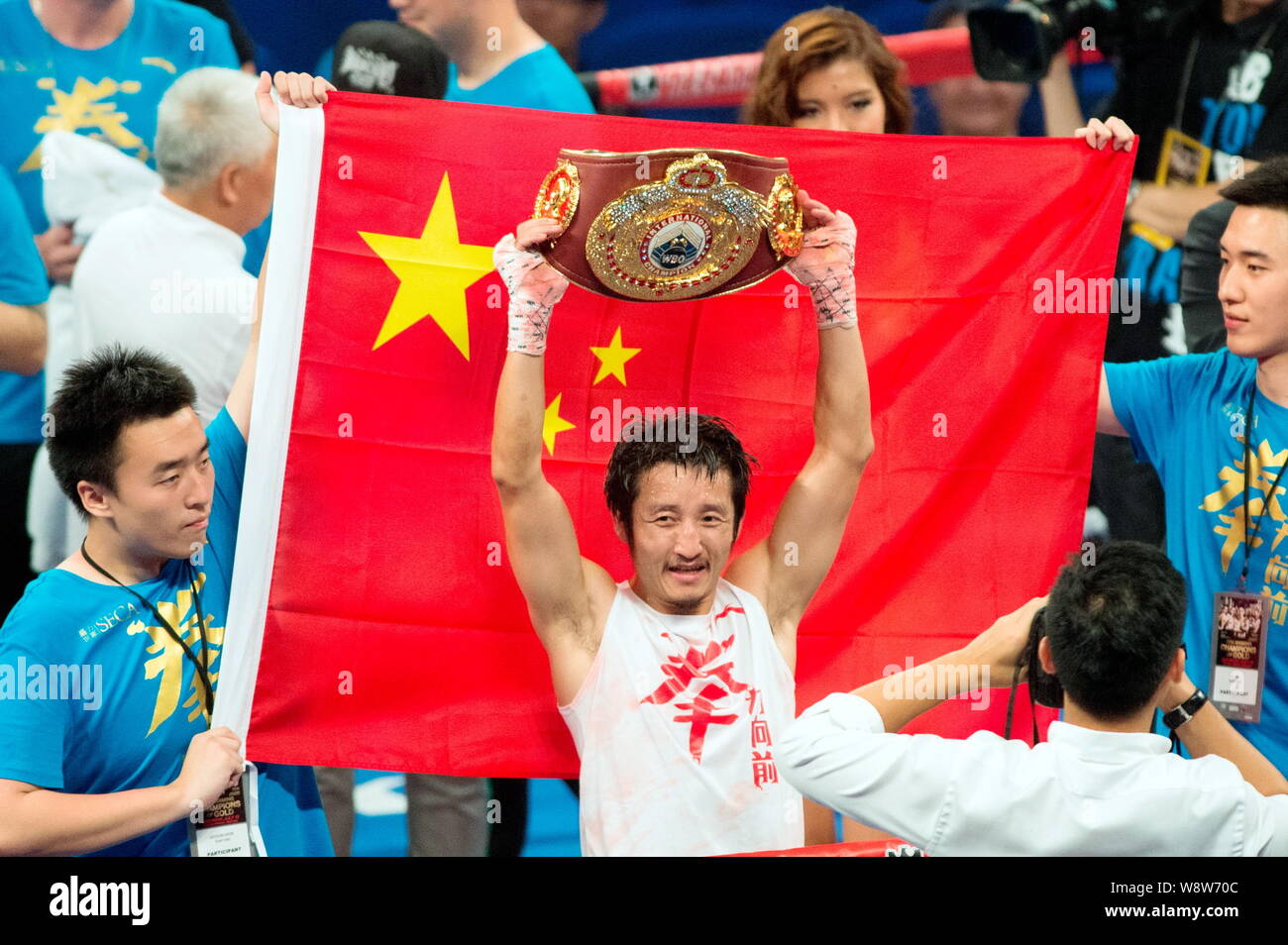 --FILE--Chinese boxer Zou Shiming, center, holds up his belt after ...