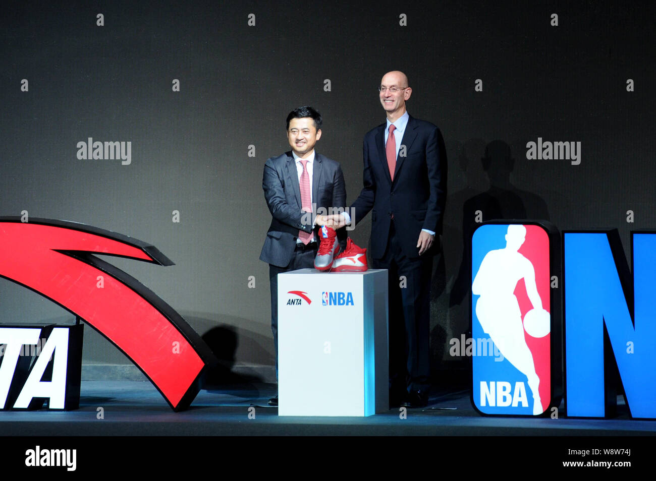 NBA Commissioner Adam Silver, right, shakes hands with Ding Zhizhong ...