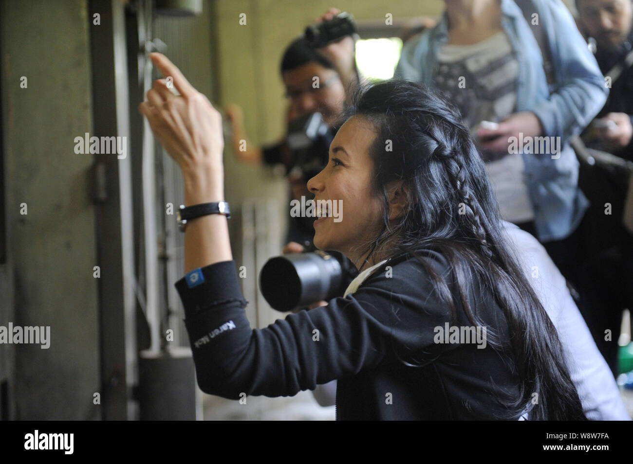 Hong Kong singer and actress Karen Mok smiles as she looks at the black ...