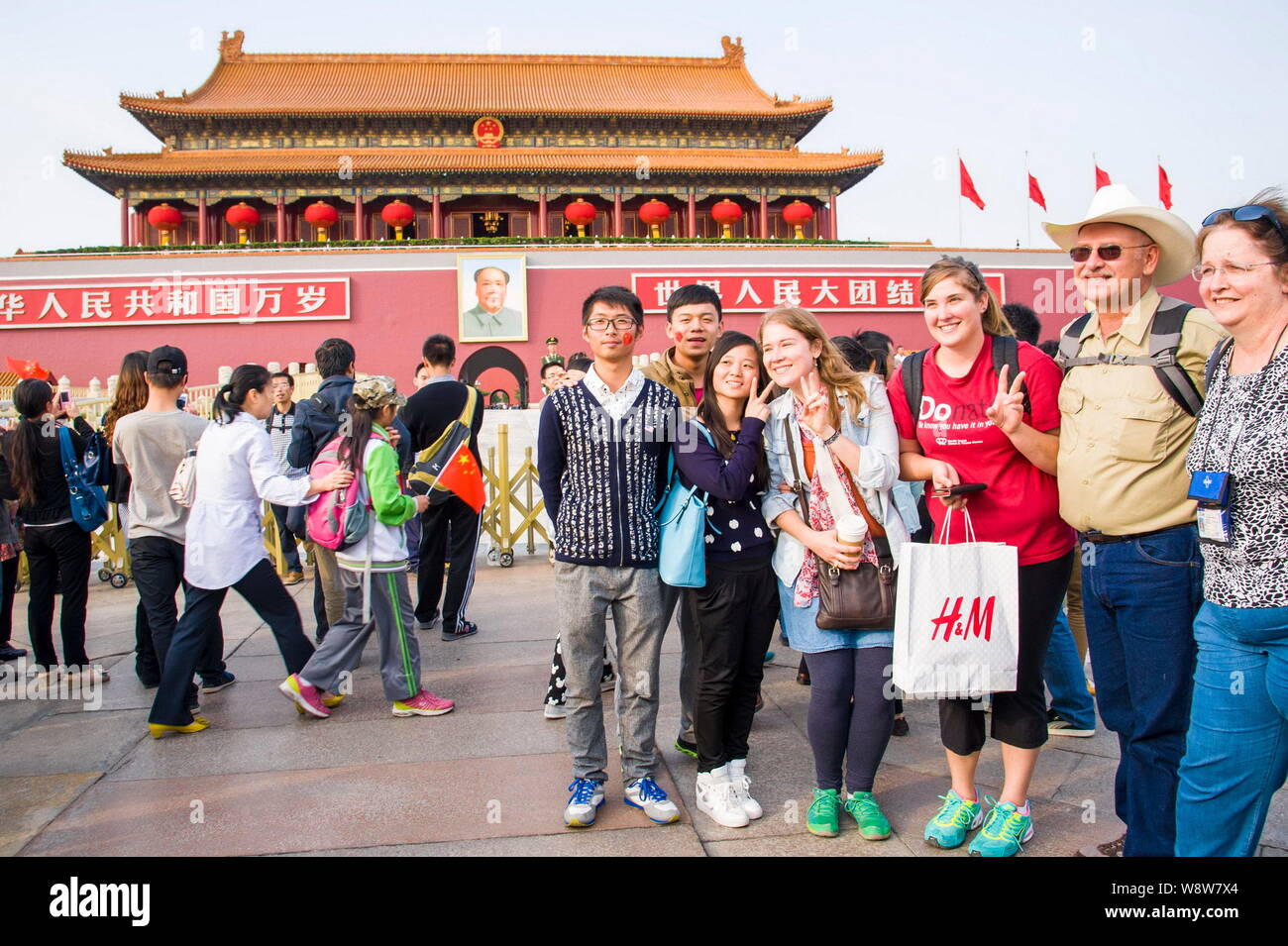 Chinese and foreign tourists pose for photos on the Tian'anmen Square ...