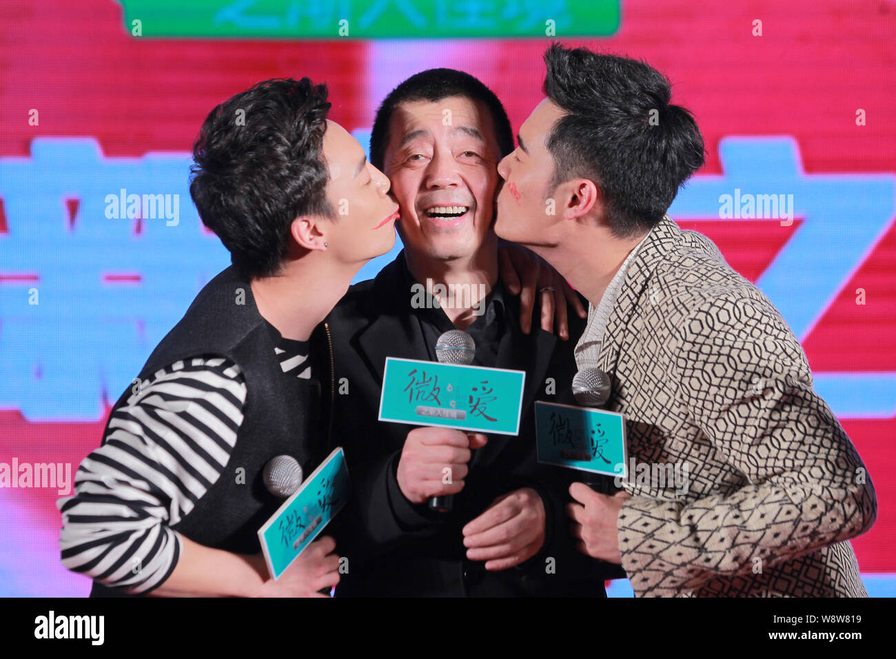 Chinese actors Cao Lu, left, and Chen He, right, kiss director Gu ...