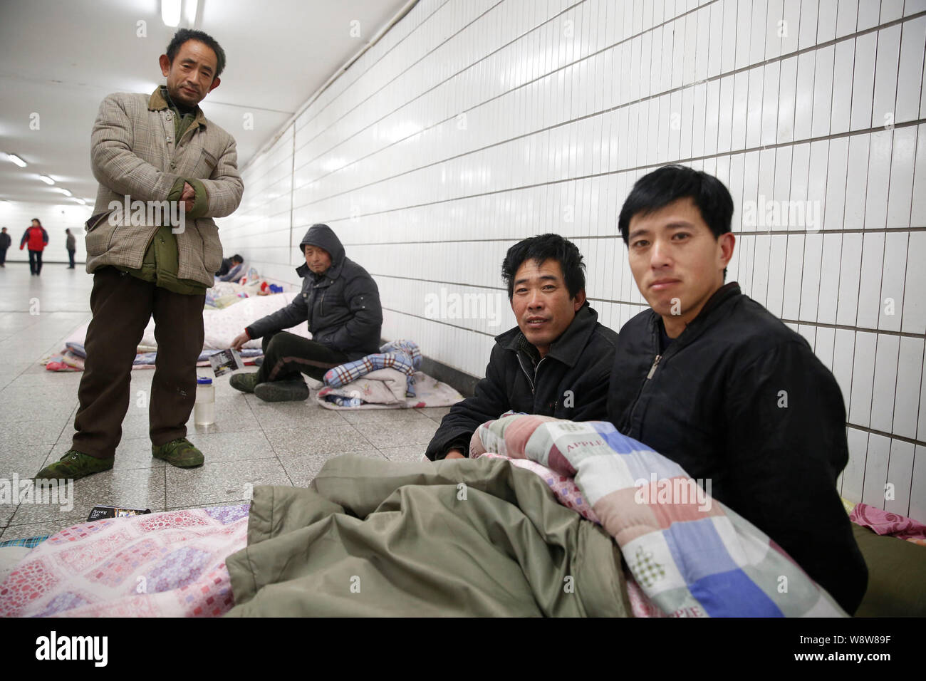 Migrant workers gather in an underground passage of the Chaoyangmen ...