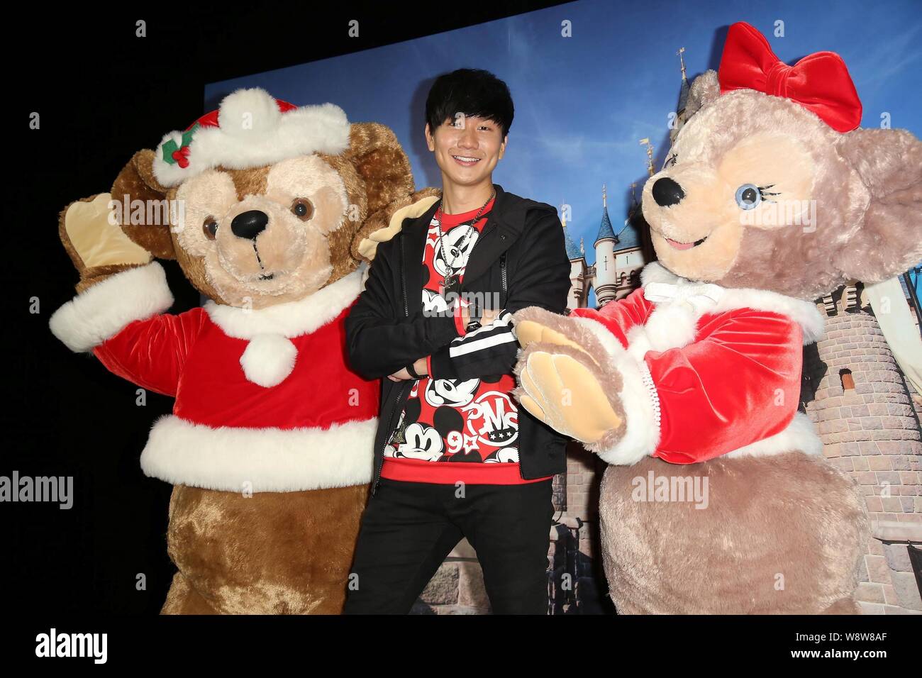 Singaporean singer JJ Lin, center, poses with two mascot bears at a ...