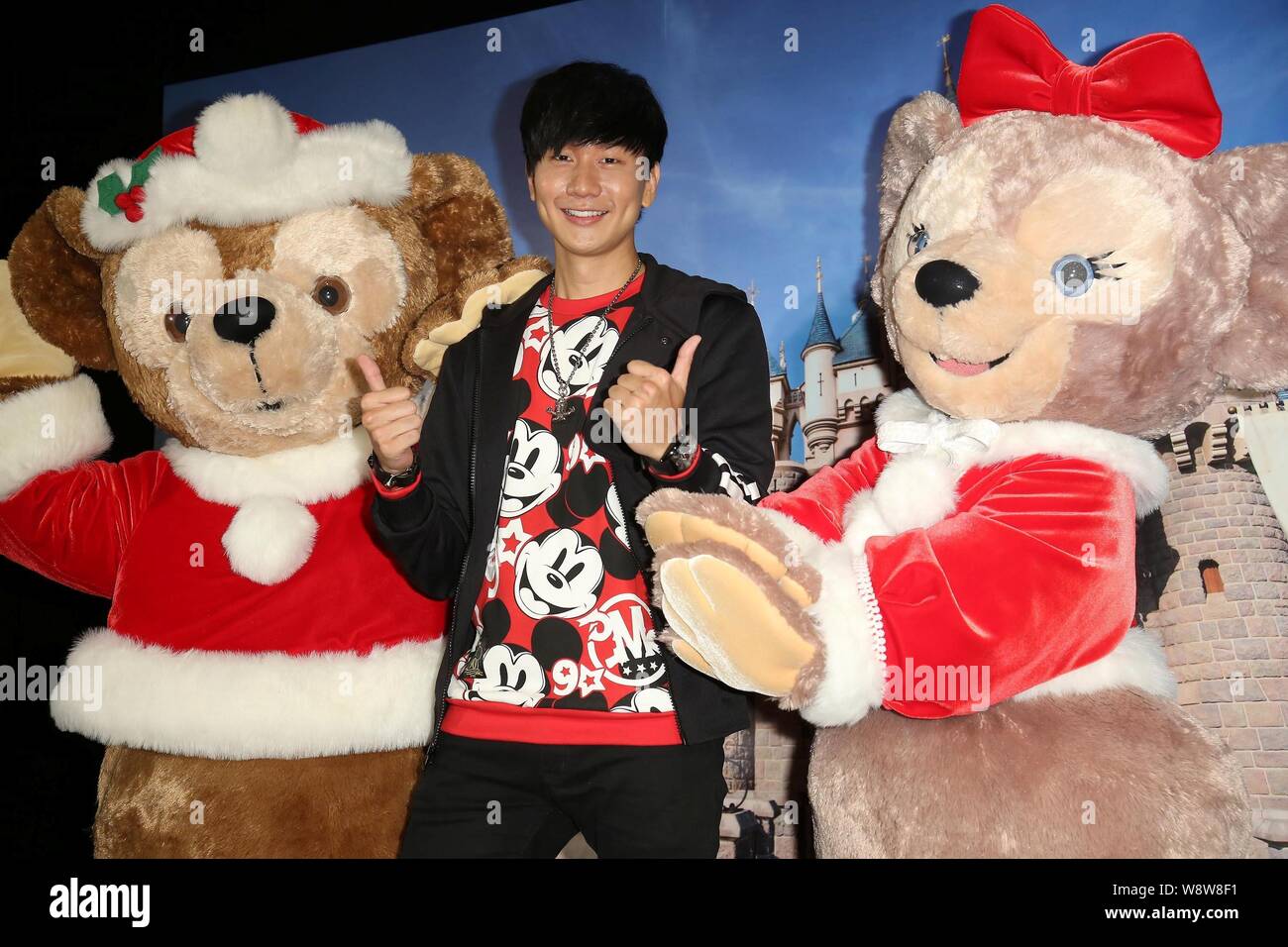 Singaporean singer JJ Lin, center, poses with two mascot bears at a ...