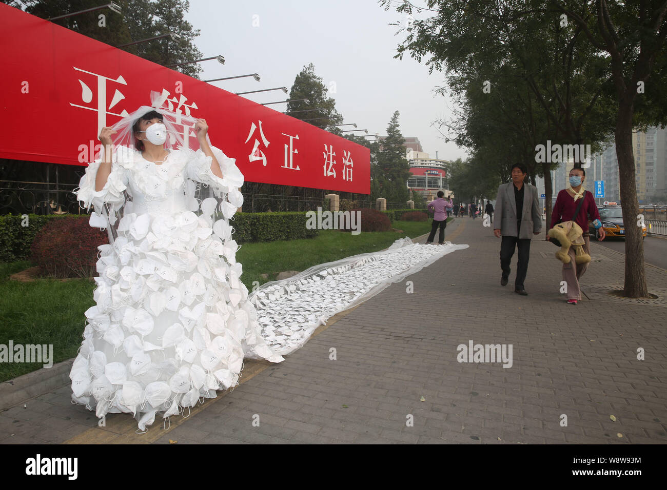 Chinese artist Kong Ning dressed in a 10-meter-long wedding gown made ...