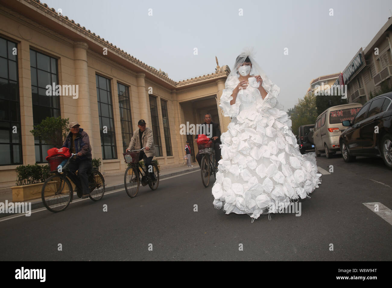 Chinese artist Kong Ning dressed in a 10-meter-long wedding gown made ...