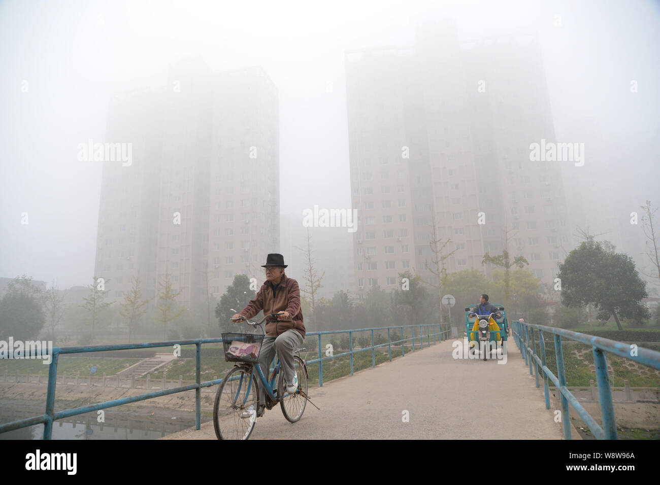 Cyclists ride on a road in heavy smog in Handan city, north Chinas ...