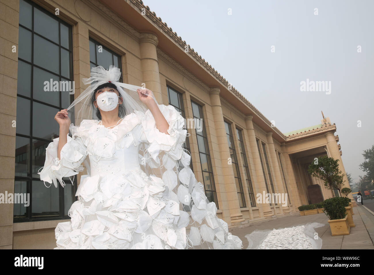 Chinese artist Kong Ning dressed in a 10-meter-long wedding gown made ...