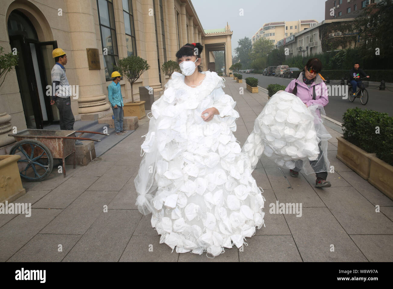 Chinese artist Kong Ning dressed in a 10-meter-long wedding gown made ...