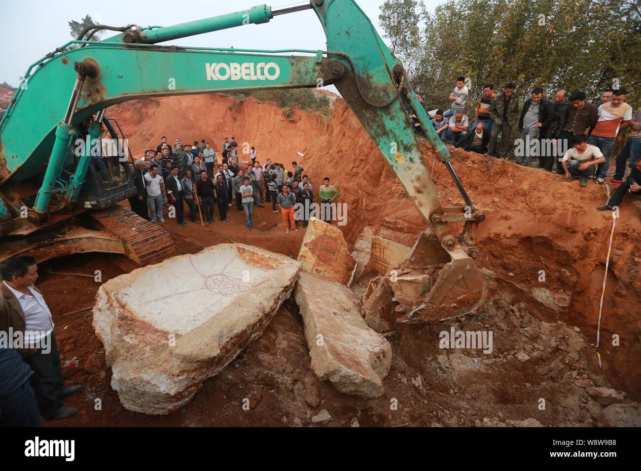 An excavator digs on the site of an ancient tomb where several Ming ...