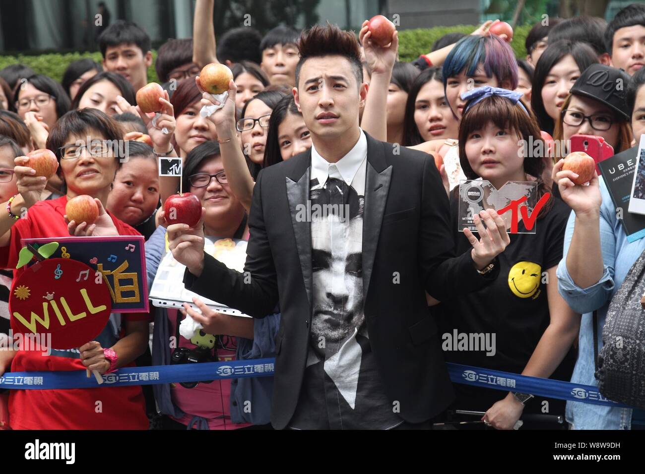 Taiwanese signer Wilber Pan, front, poses with fans during a press ...