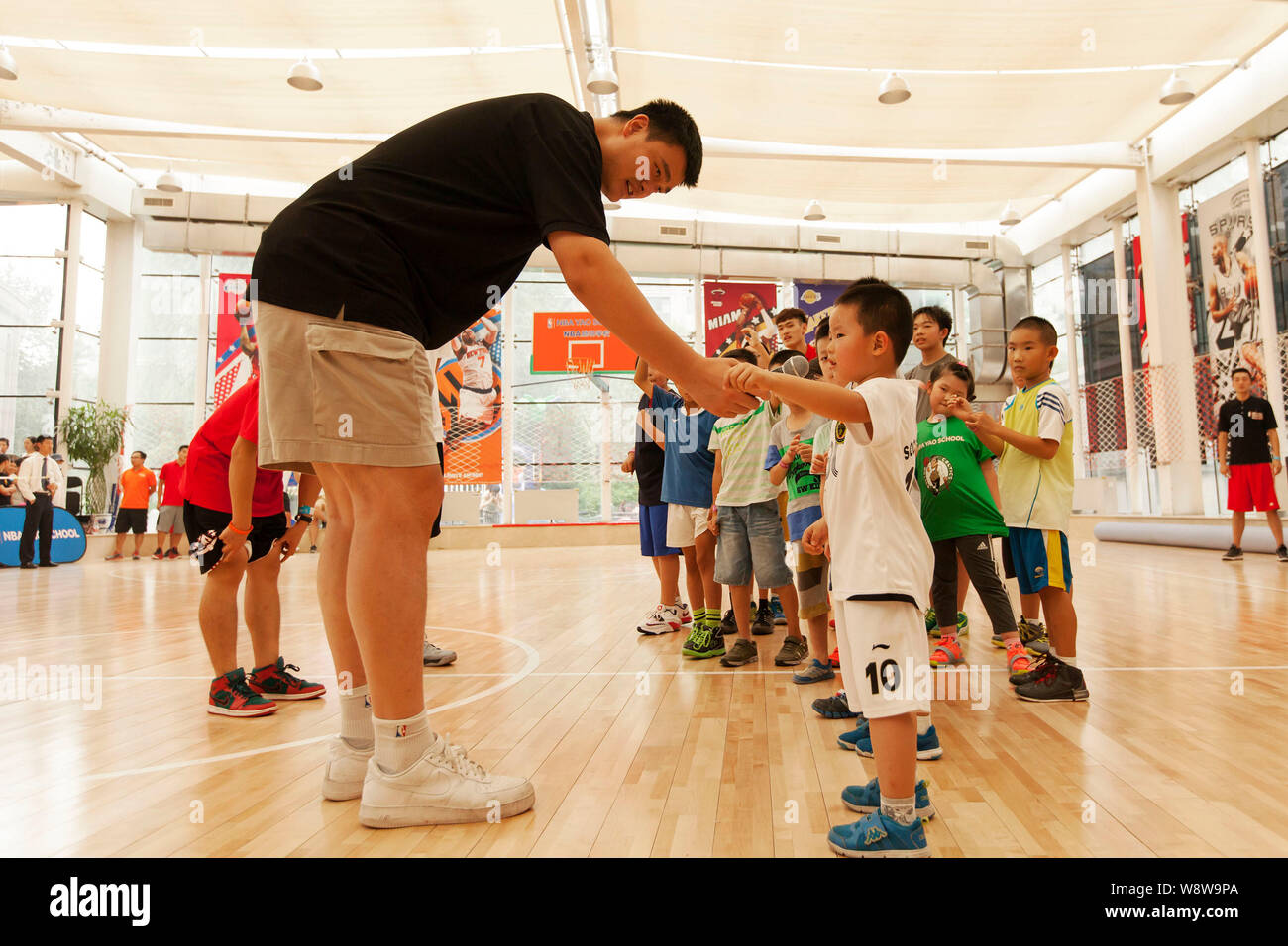 Retired Chinese basketball star Yao Ming, left, shakes hands with a ...