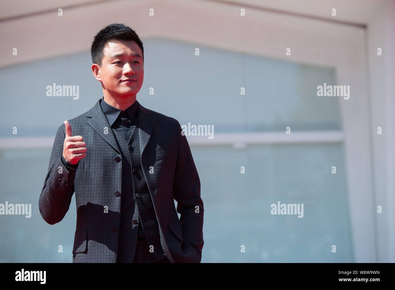Chinese actor Tong Dawei poses on the red carpet as he arrives for the ...