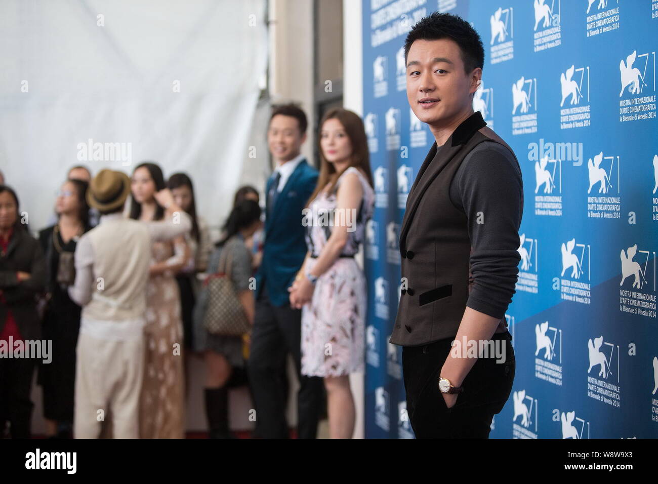 Chinese actor Tong Dawei, front, poses at the photocall for his new ...