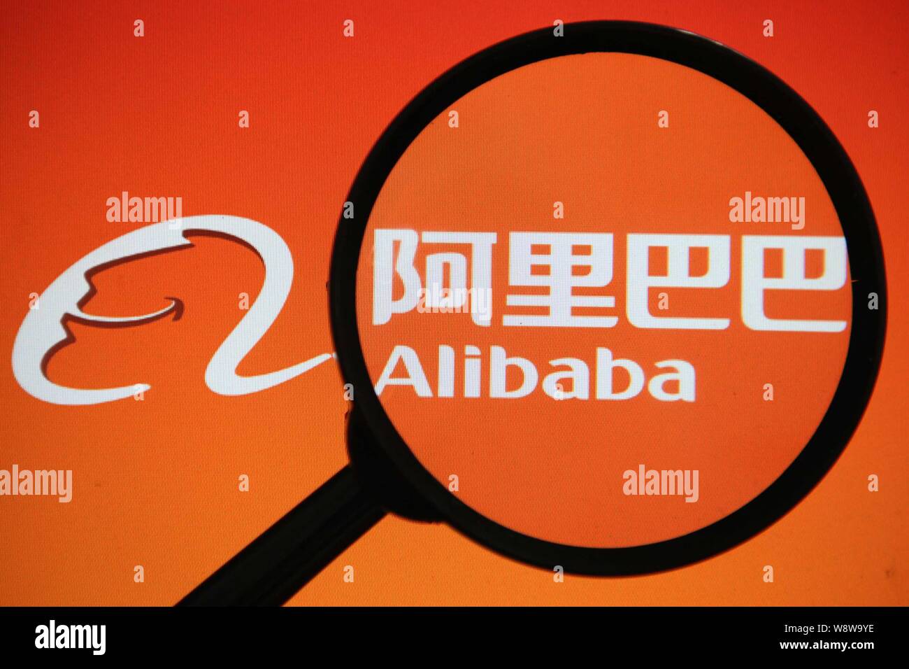 A Chinese resident looks at a logo of Alibaba in Shanghai, China, 4 ...