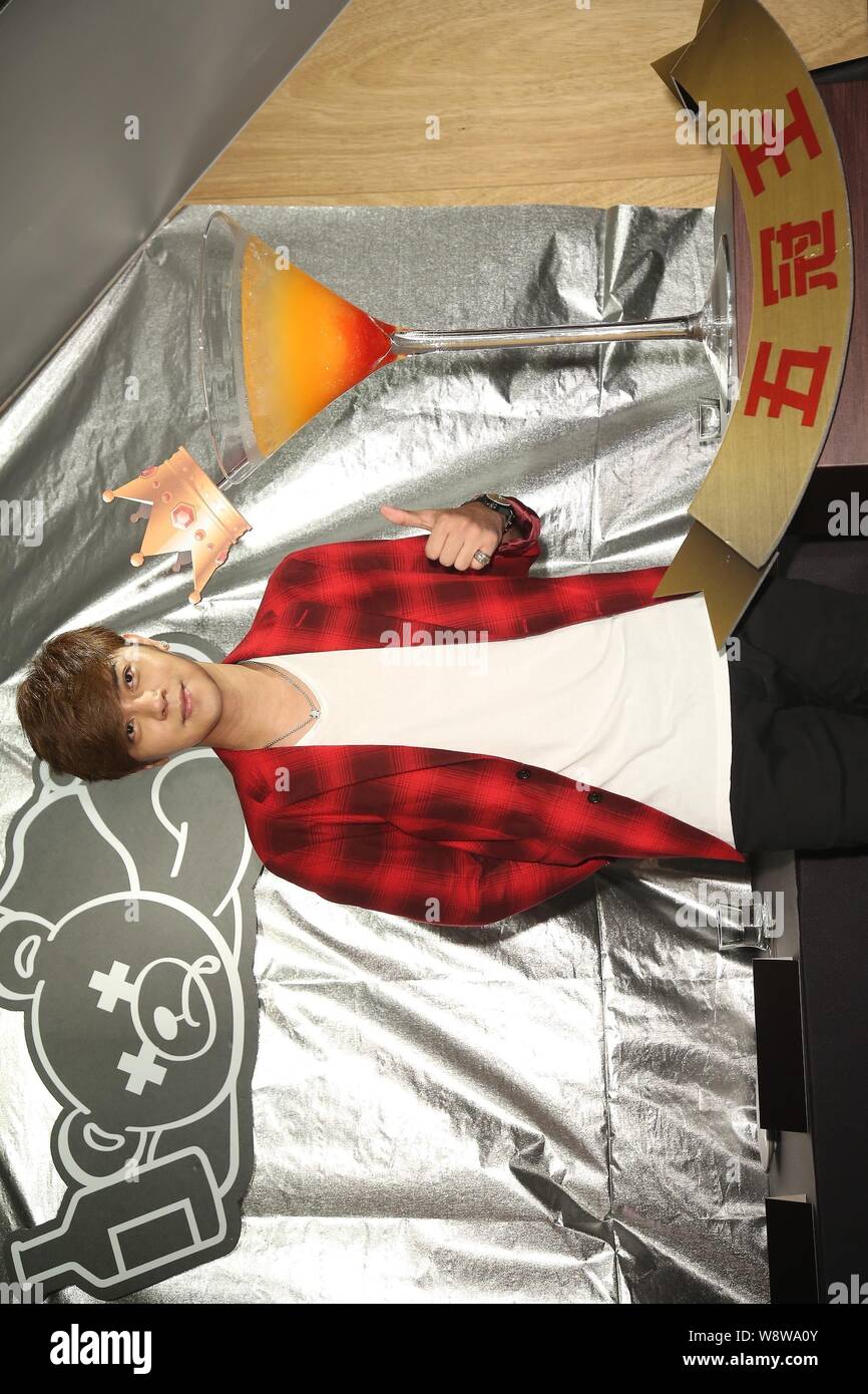 Taiwanese singer Show Lo poses next to an oversized mug of mixed drink ...