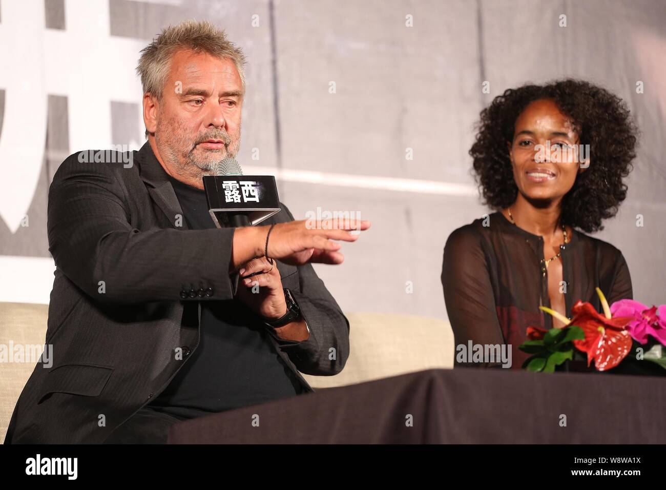 French director Luc Besson, left, speaks as his producer wife Virginie ...