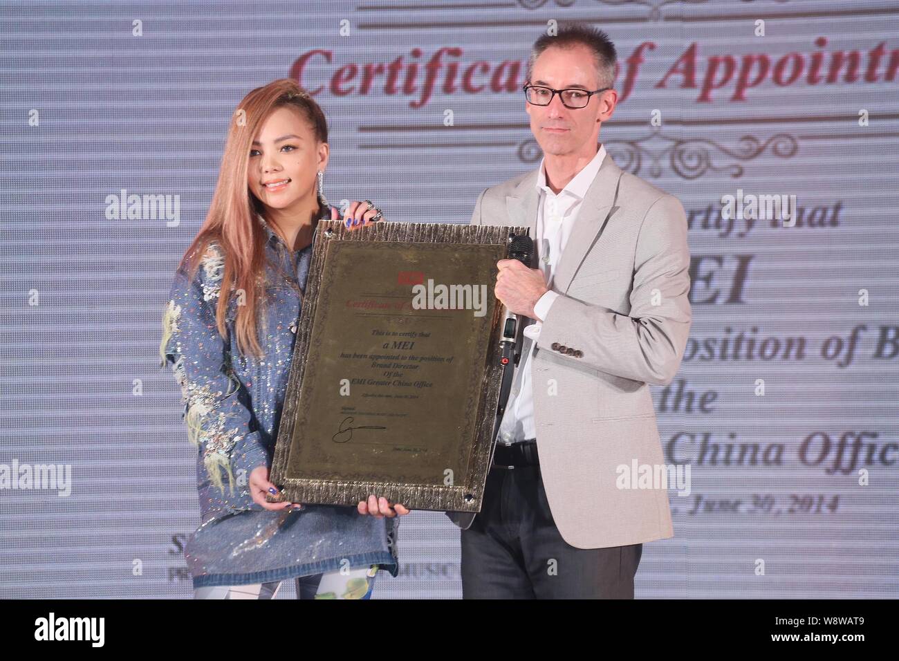 Taiwanese singer A-Mei, left, receives a certificate of appointment ...