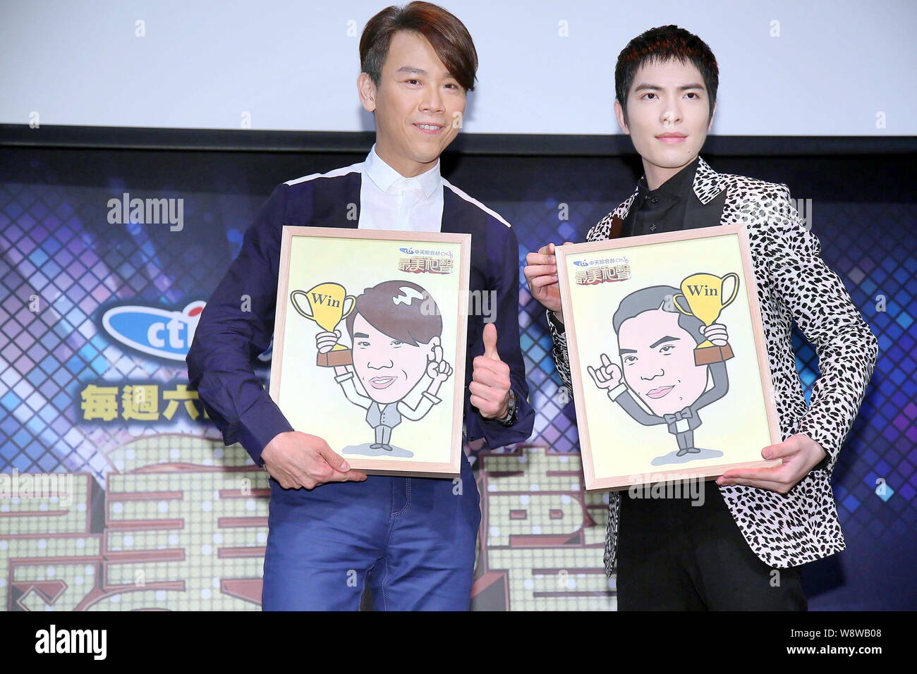 Taiwanese singers David Tao, left, and Jam Hsiao show their caricatures ...