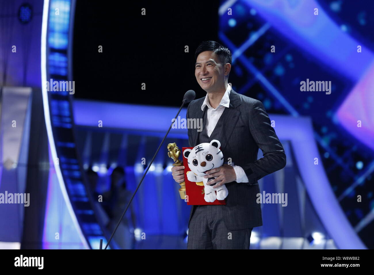 Hong Kong actor Nick Cheung holds his trophy of the Best Actor award ...