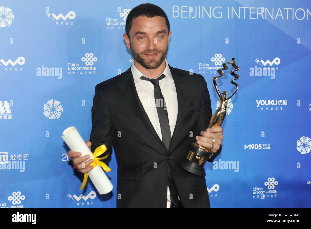 French actor Guillaume Gouix poses with his trophy of the Best Actor ...