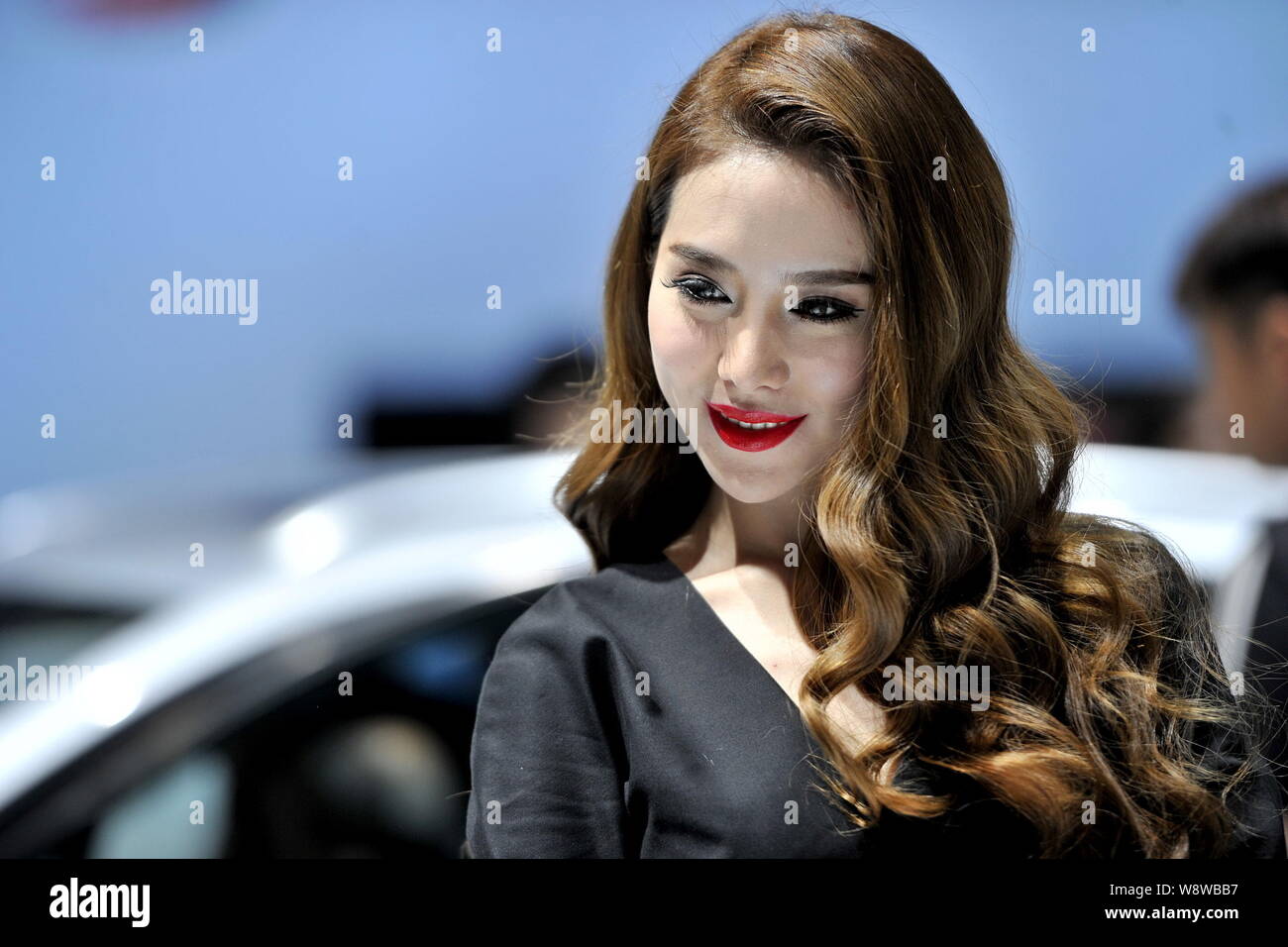 A model poses at the stand of Porsche during the 13th Beijing ...