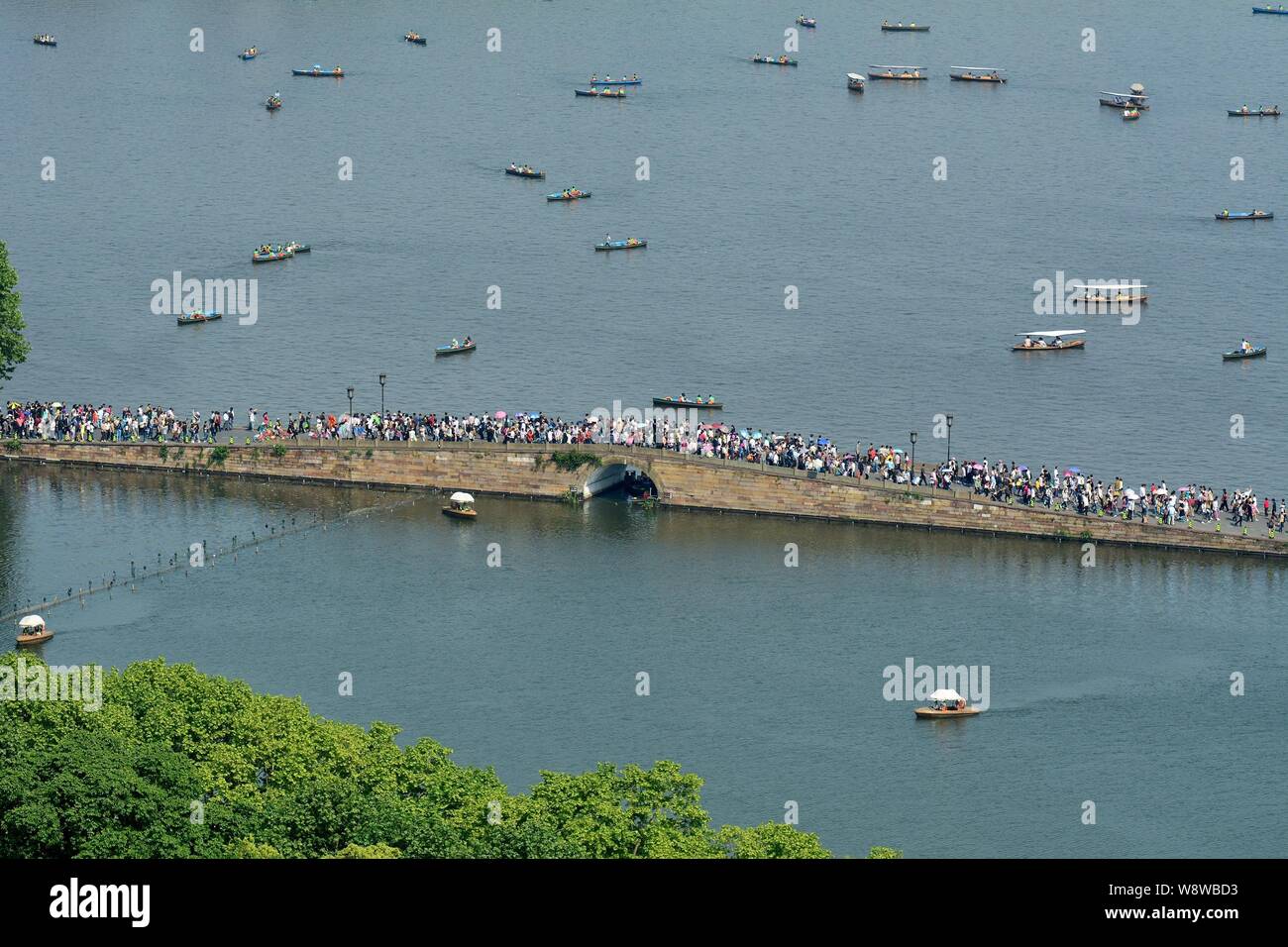 Tourists crowd on the Bai Causeway at the West Lake during the May Day ...
