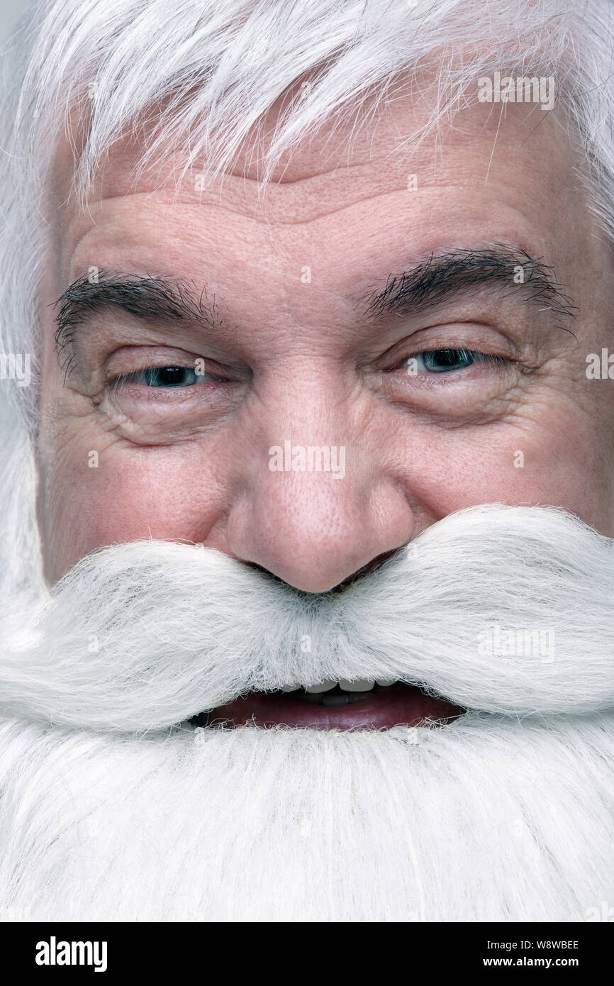 Close-up of the face of a Santa Claus. White-haired elderly man with ...