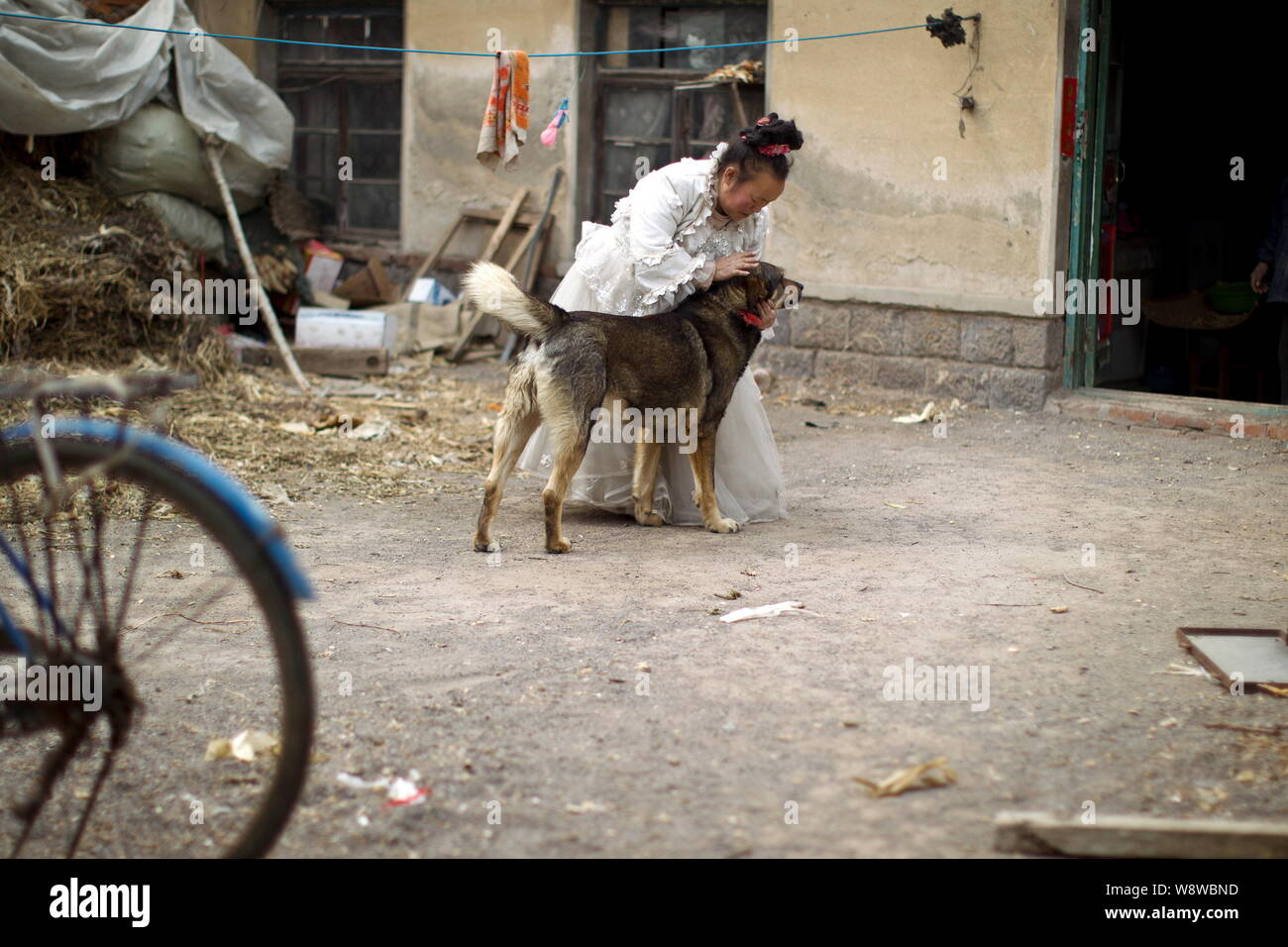 47-year-old Chinese villager Xiang Junfeng, dressed in a white wedding ...