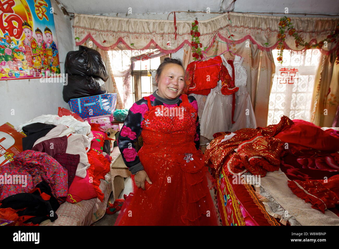 47-year-old Chinese villager Xiang Junfeng, dressed in a red wedding ...