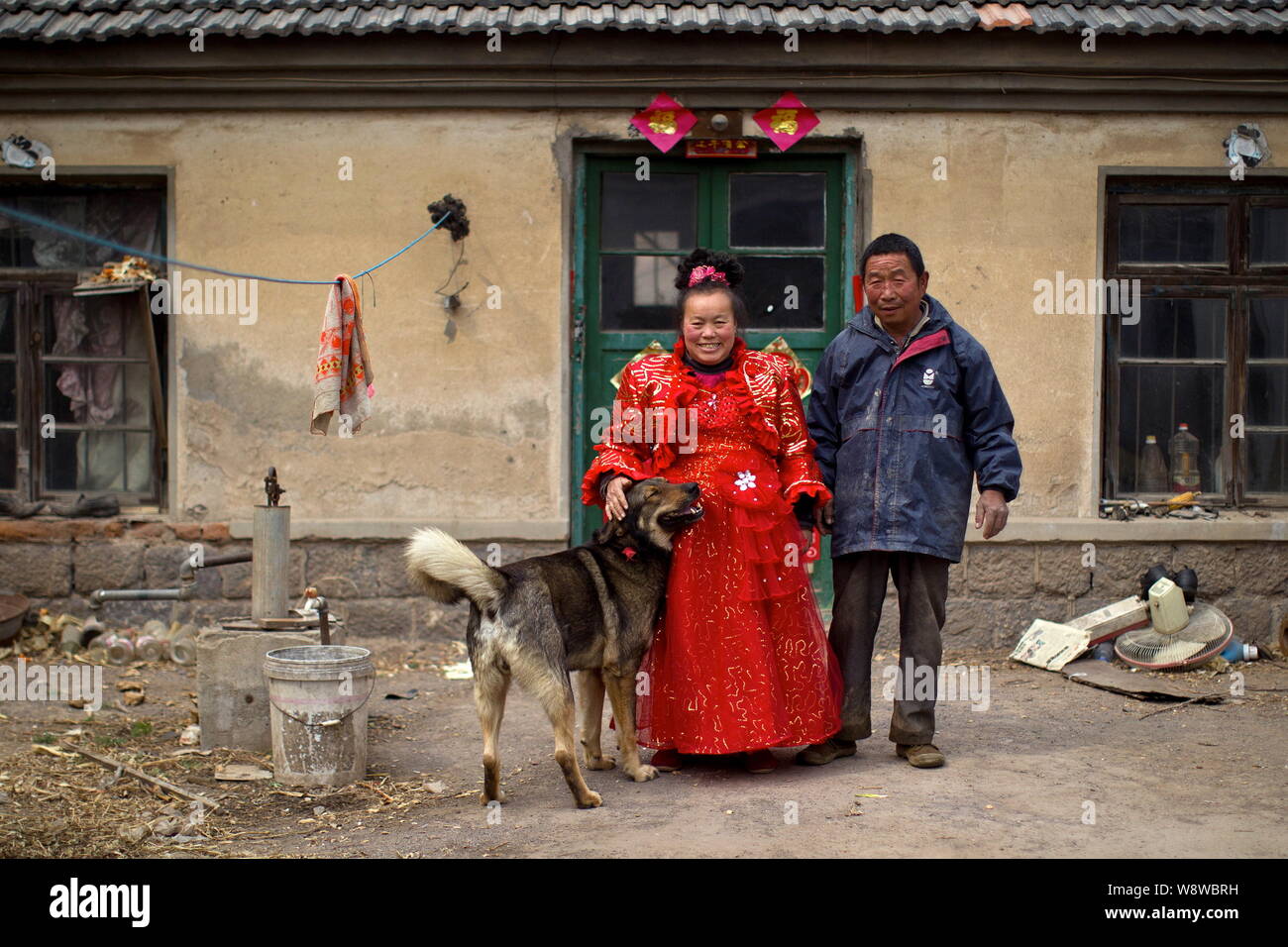 47-year-old Chinese villager Xiang Junfeng, dressed in a red wedding ...
