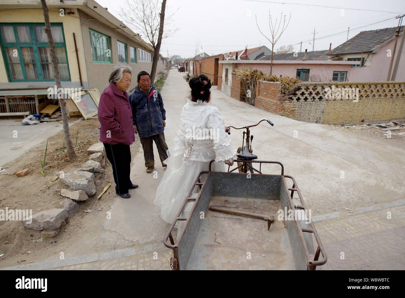 47-year-old Chinese villager Xiang Junfeng, dressed in a white wedding ...