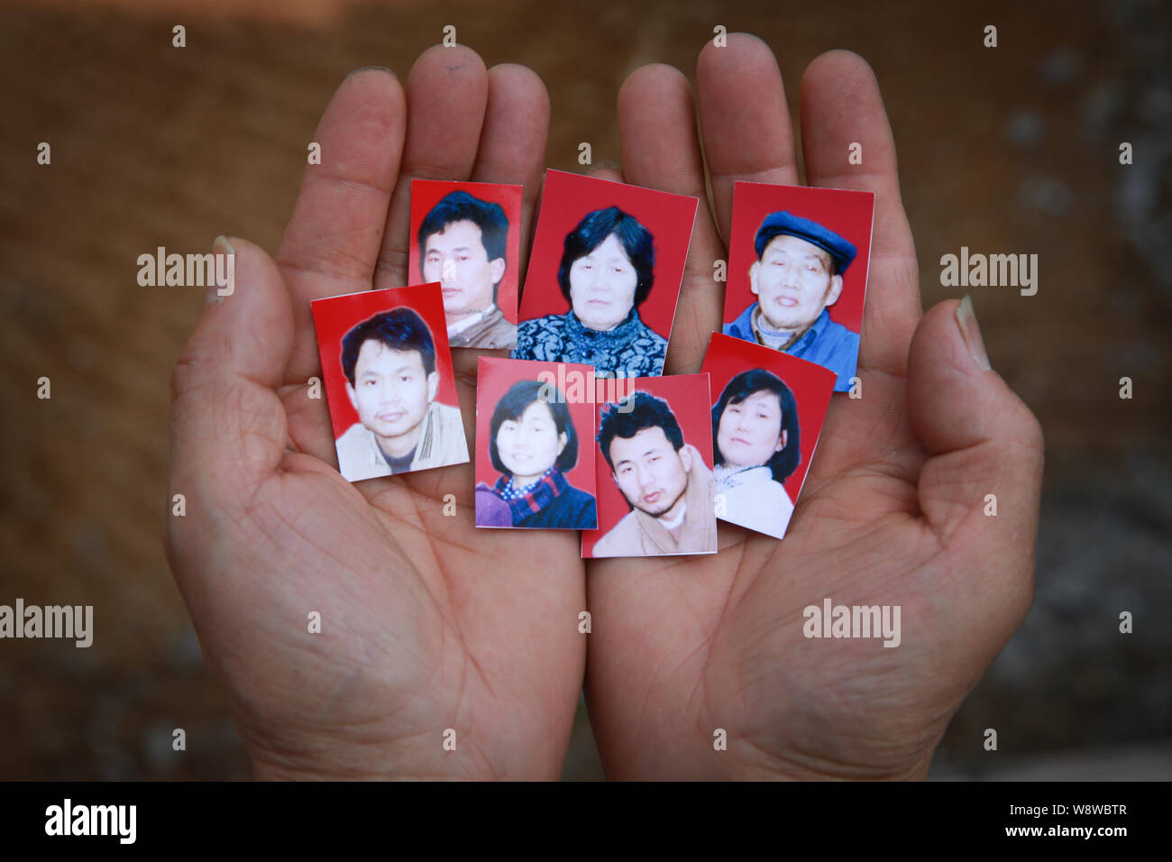 Chinese villager Zhu Chunran shows photos of his father-in-law Wang ... Chinese villager Zhu Chunran shows photos of his father-in-law Wang ...