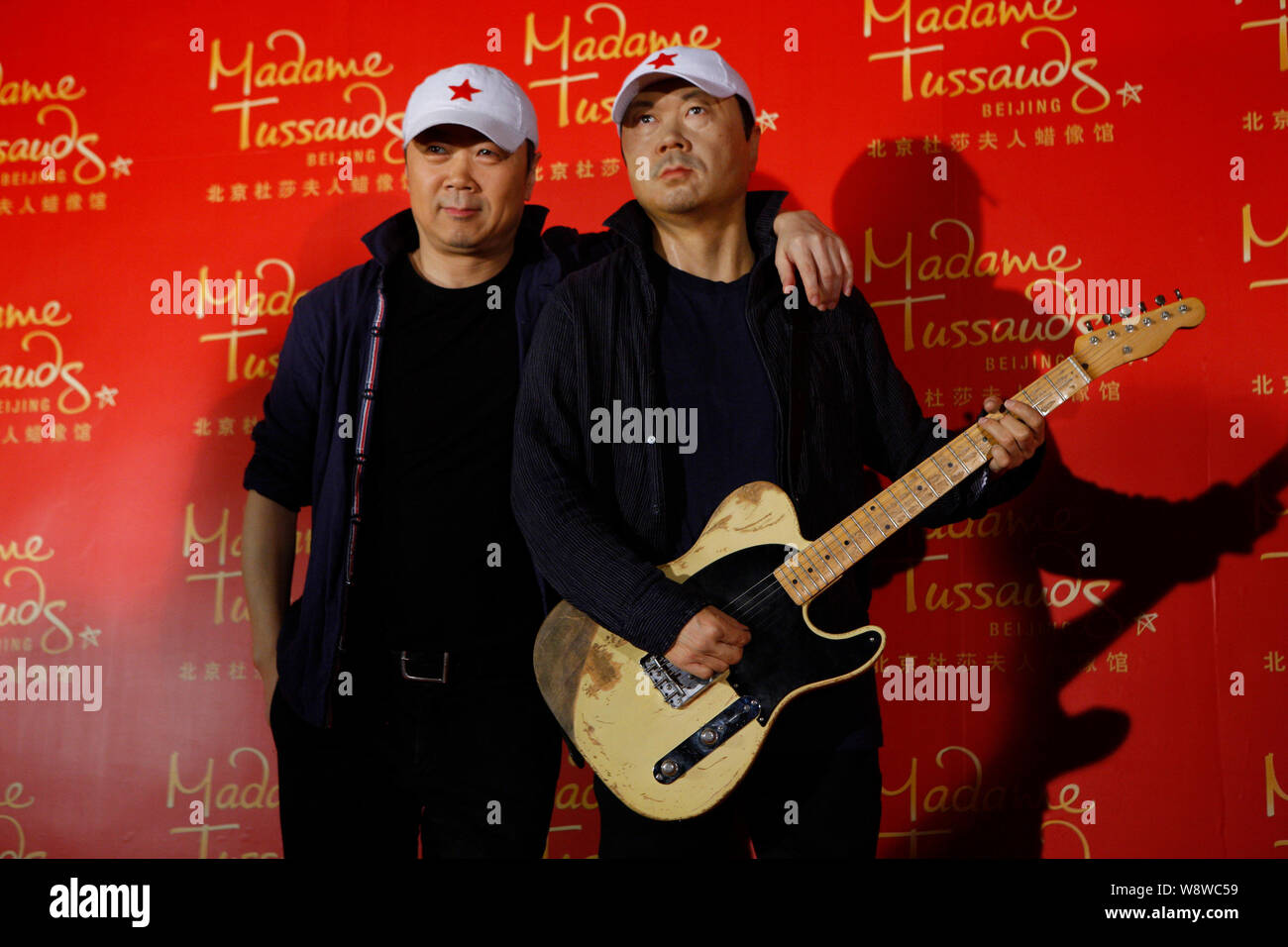 Chinese singer-songwriter Cui Jian, left, poses with the wax figure of ...