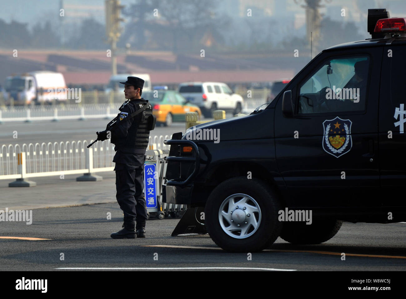 An armed police officer stands guard at the Tiananmen Square in Beijing ...