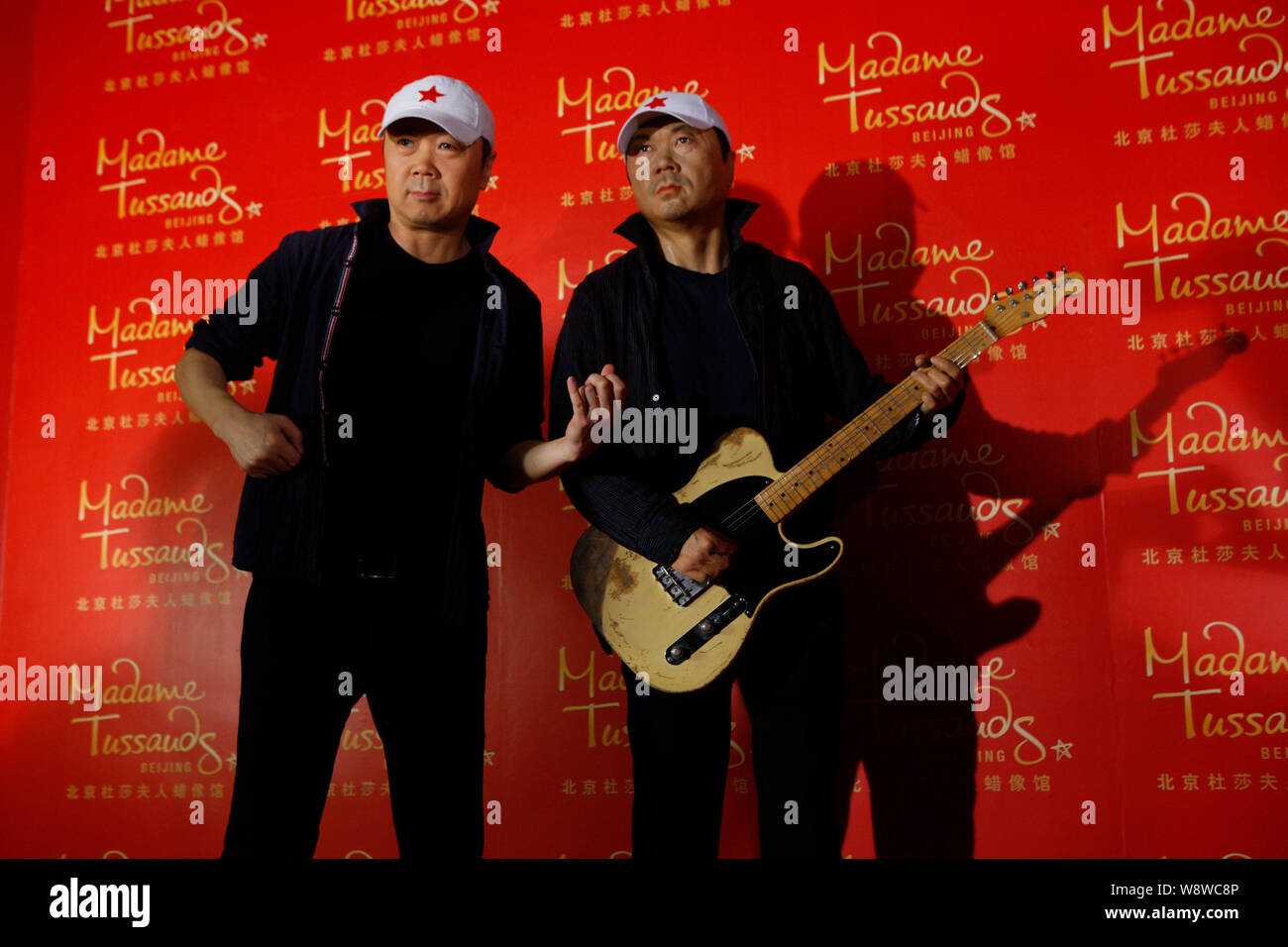 Chinese singer-songwriter Cui Jian, left, poses with the wax figure of ...