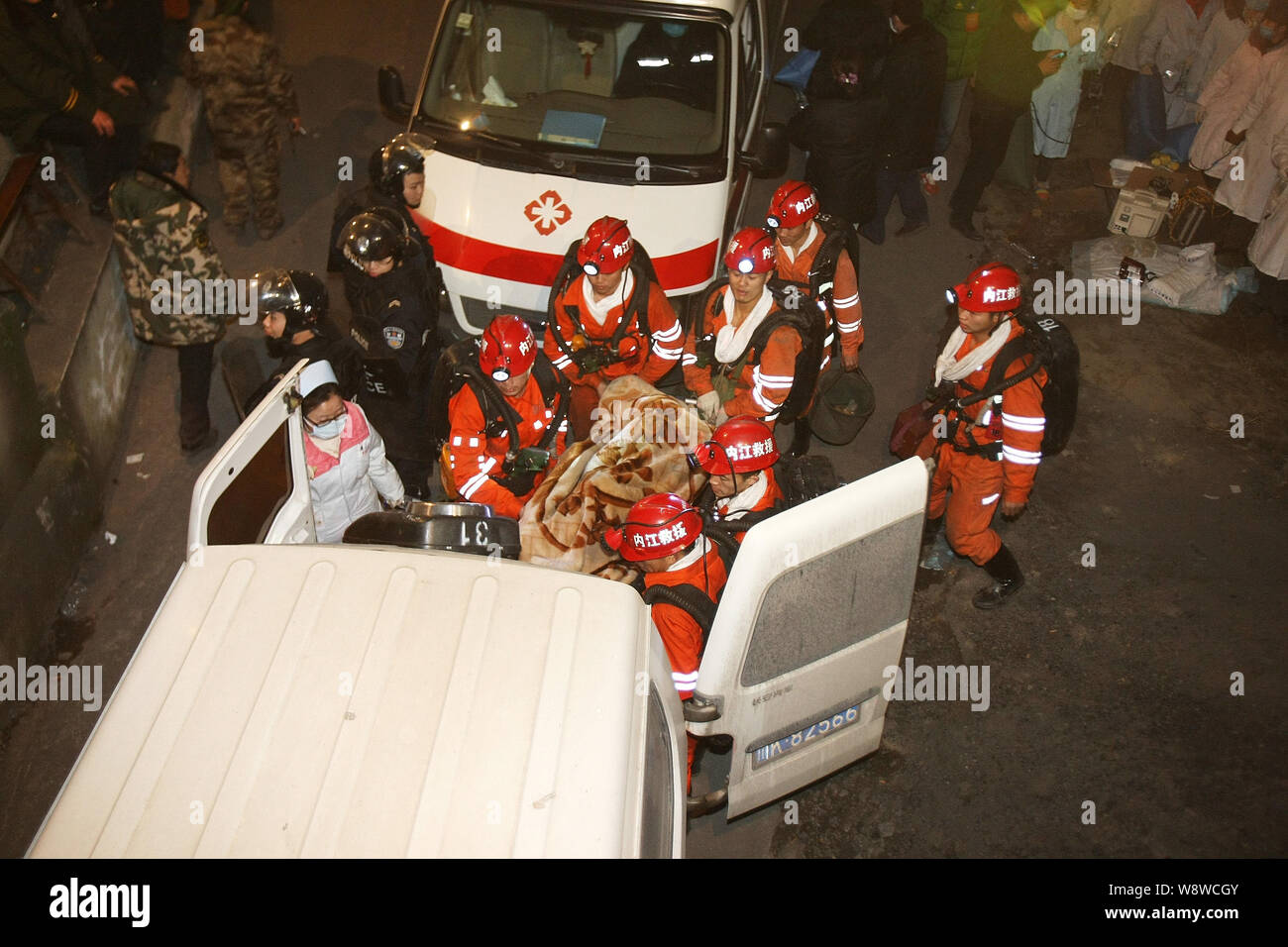 Rescuers put a miner into an ambulance after the gas explosion at a ...